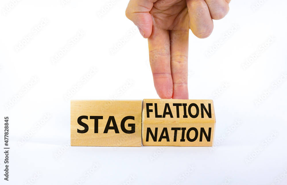 Stagflation or stagnation symbol. Businessman turns cubes, changes the ...