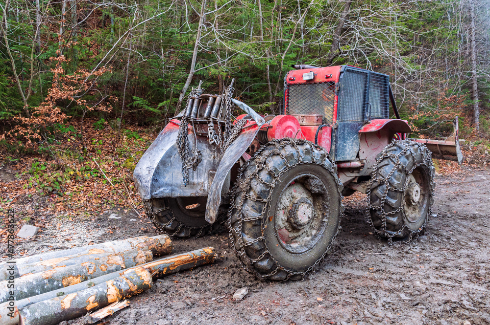 The red skidder in the forest. The timber skidding machine. Large ...