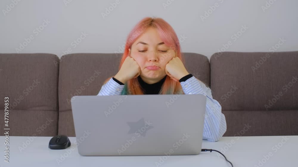 Confused girl thinking in front of laptop computer at home. Cute young ...