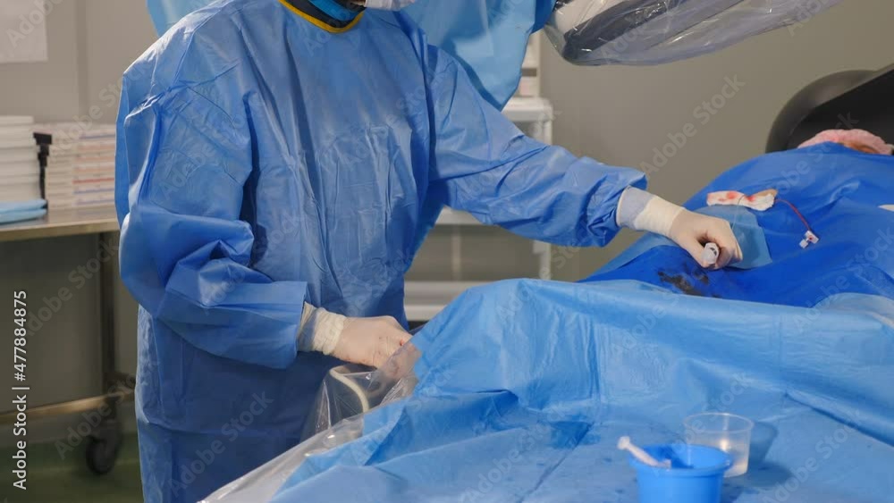 Vascular surgery in modern clinic. wound on arm. Surgeons using ...