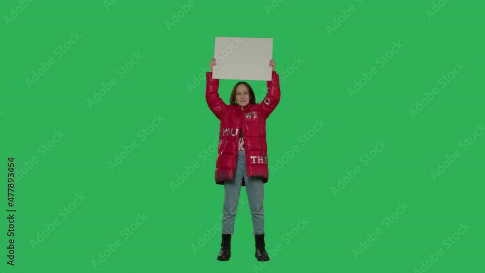 Teen girl holding placard cardboard isolated over chroma key. Female ...