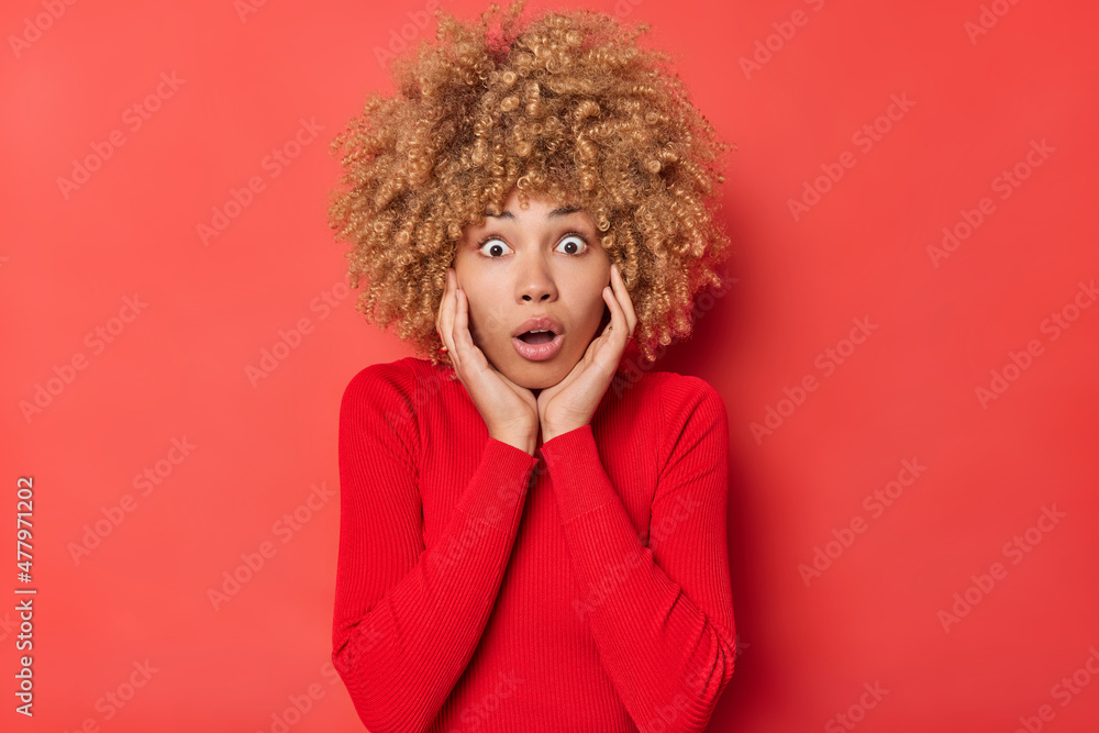 Photo of shocked pop eyed woman grabs face keeps jaw dropped hears ...