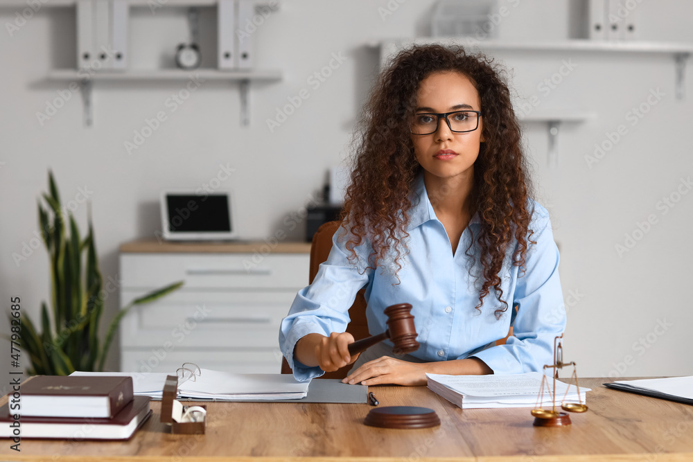 Female judge with gavel at workplace in courtroom Stock Photo | Adobe Stock