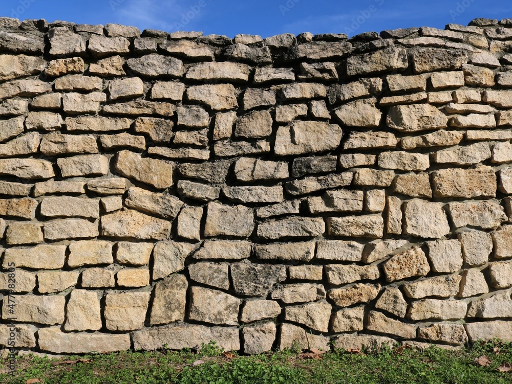 cobblestone wall with a rough, clear texture and deep lines between ...