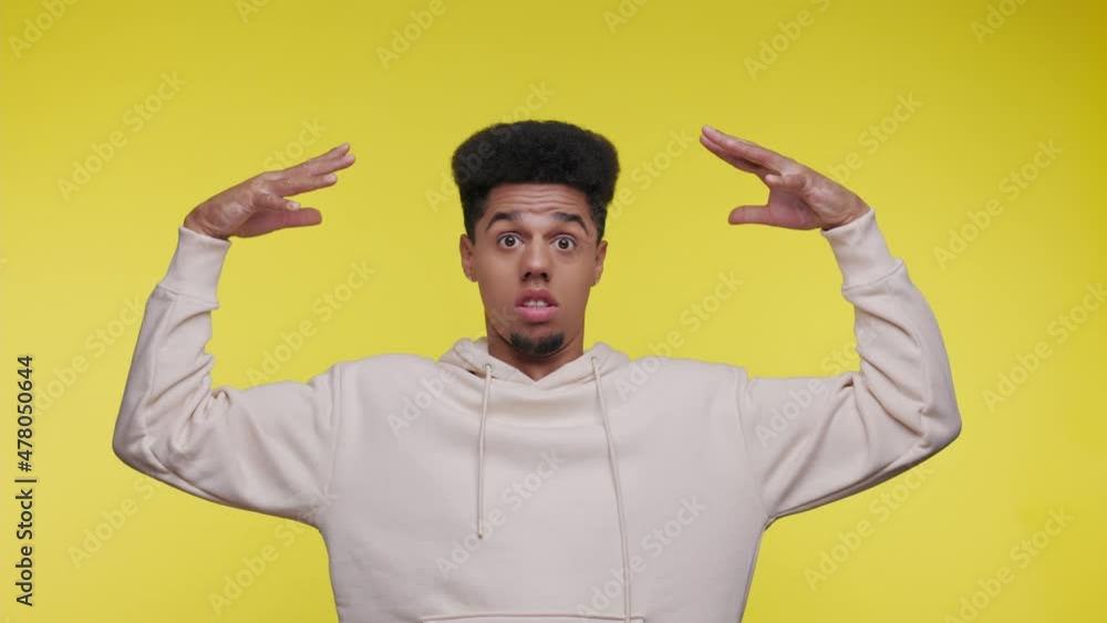 Handsome african american guy standing isolated in studio. Young black ...