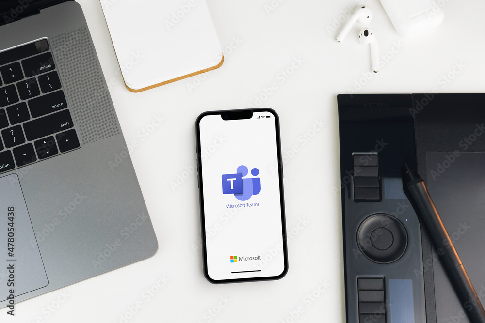 Microsoft Teams app on the smartphone screen on white background table ...