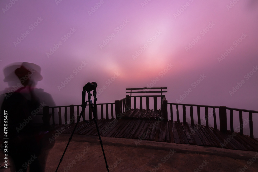 Photographer taking photo in the mist morning at wooden terrace of Baan ...