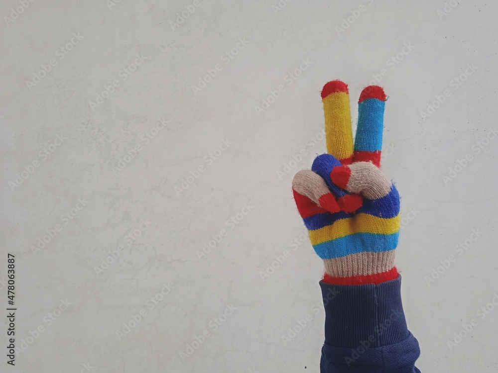 Hand wearing glove showing v peace symbol or two. Useful hand gestures ...