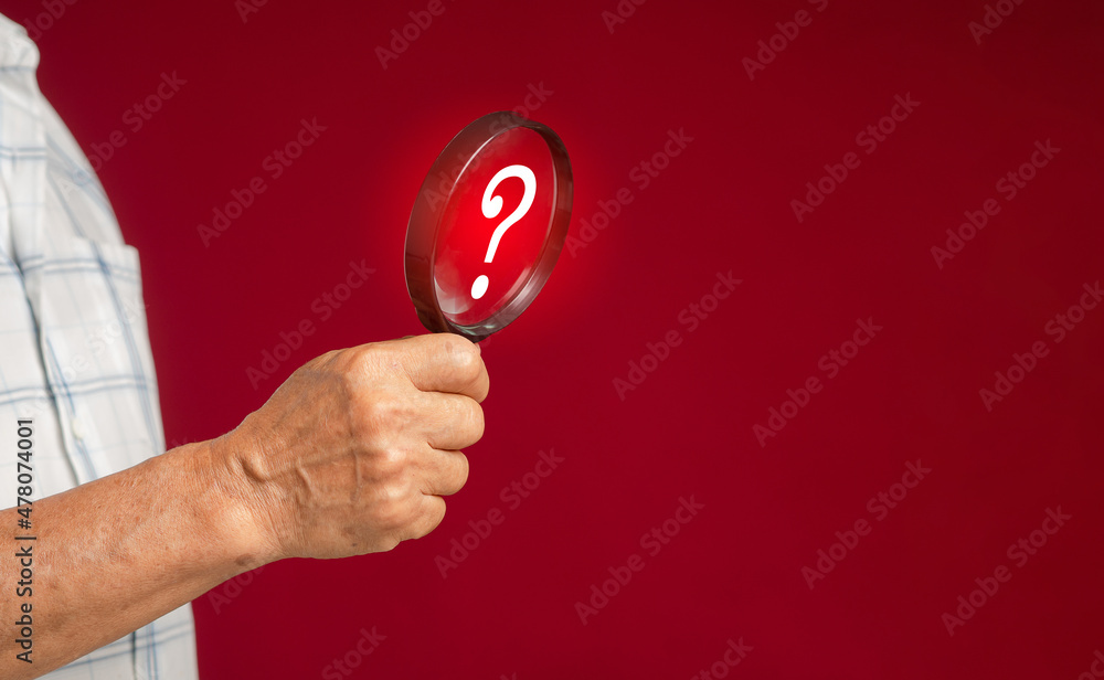 Question mark concept. Close-up of hand a senior man holding a ...