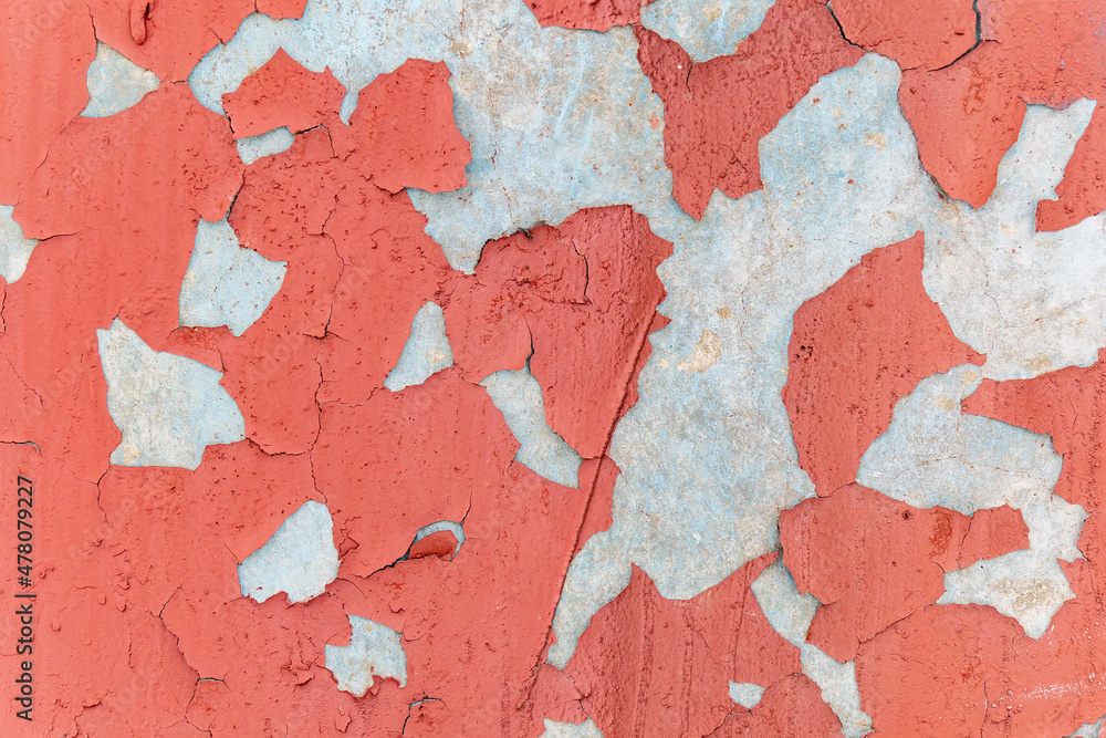 Old concrete wall with red cracked paint texture. Stains on the rough ...