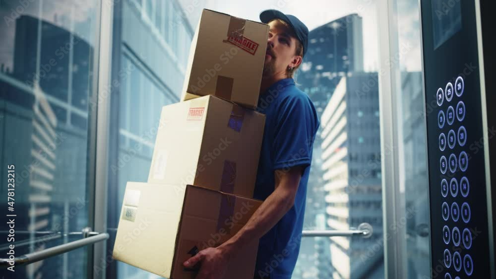 Young Delivery Person Riding Glass Elevator in Modern Office Building ...