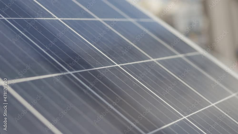 Extreme close up slide camera shot of the panels of small solar power ...