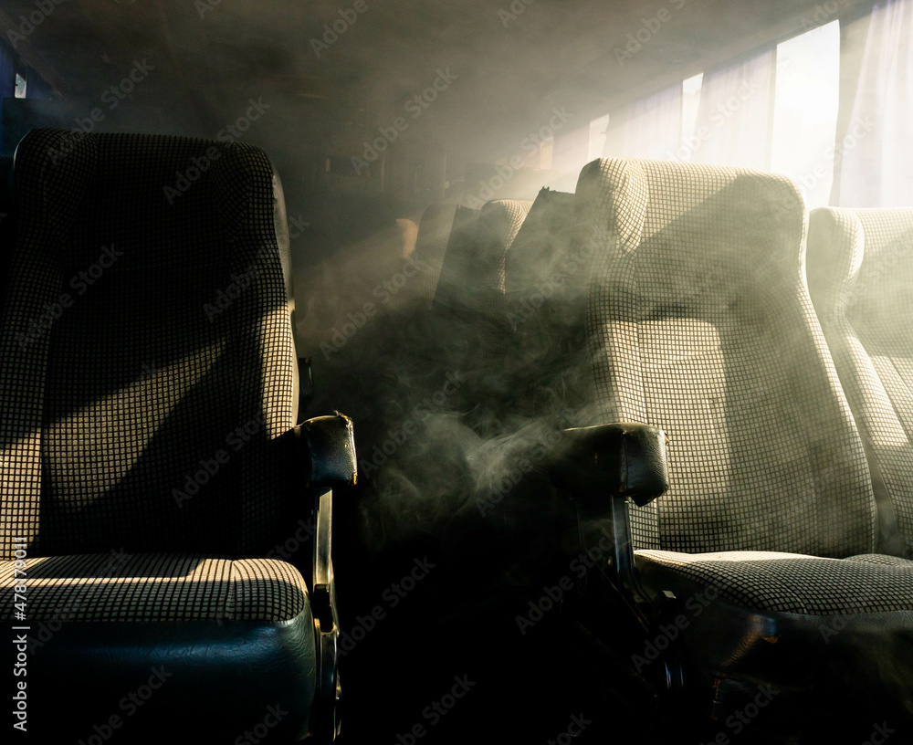 Interior of a bus with thick smoke running through the seats and spaces ...