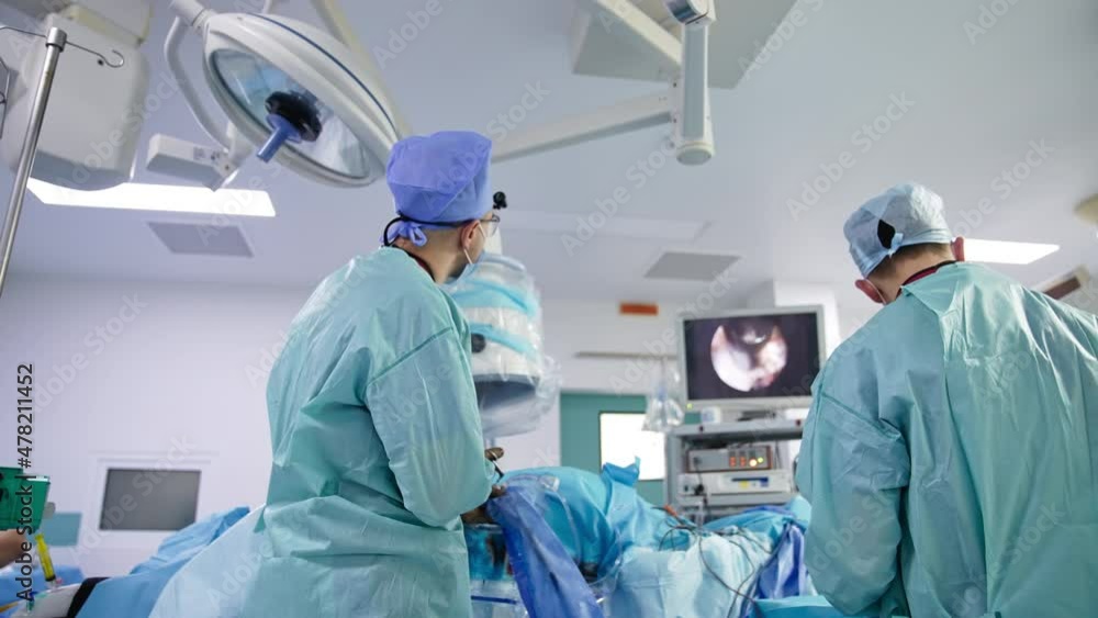 Neurosurgeons conduct the operation in modern operational theatre. Two ...