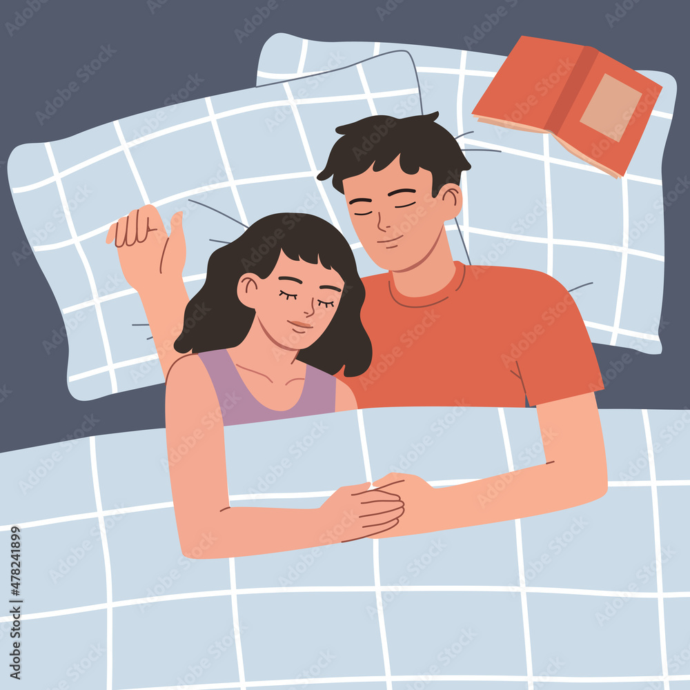 Cute young couple lying in bed. Man and woman cuddling and sleeping ...