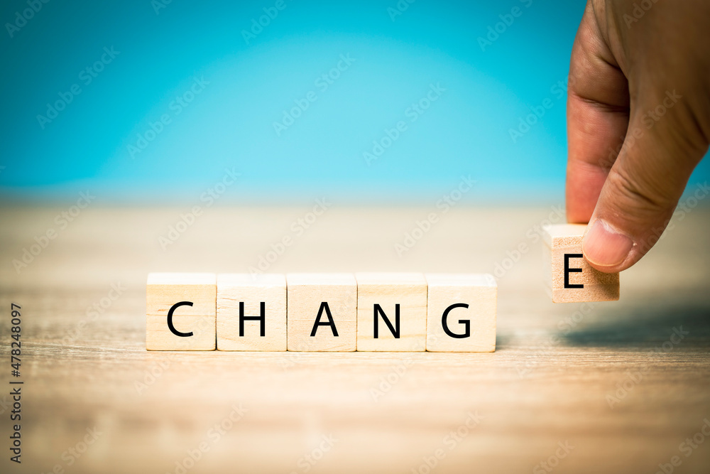Hand holding a wooden block letter e, put on the meaning of the word ...