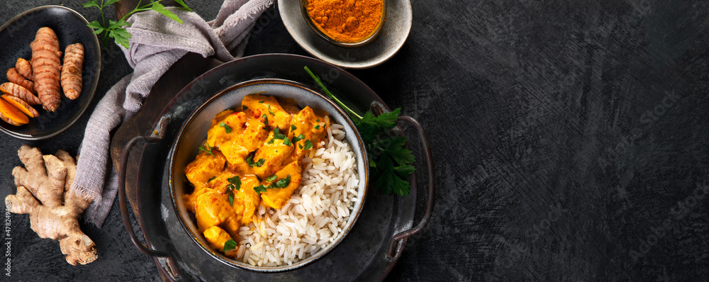 Indian butter chicken curry with basmati rice on dark background. Stock ...
