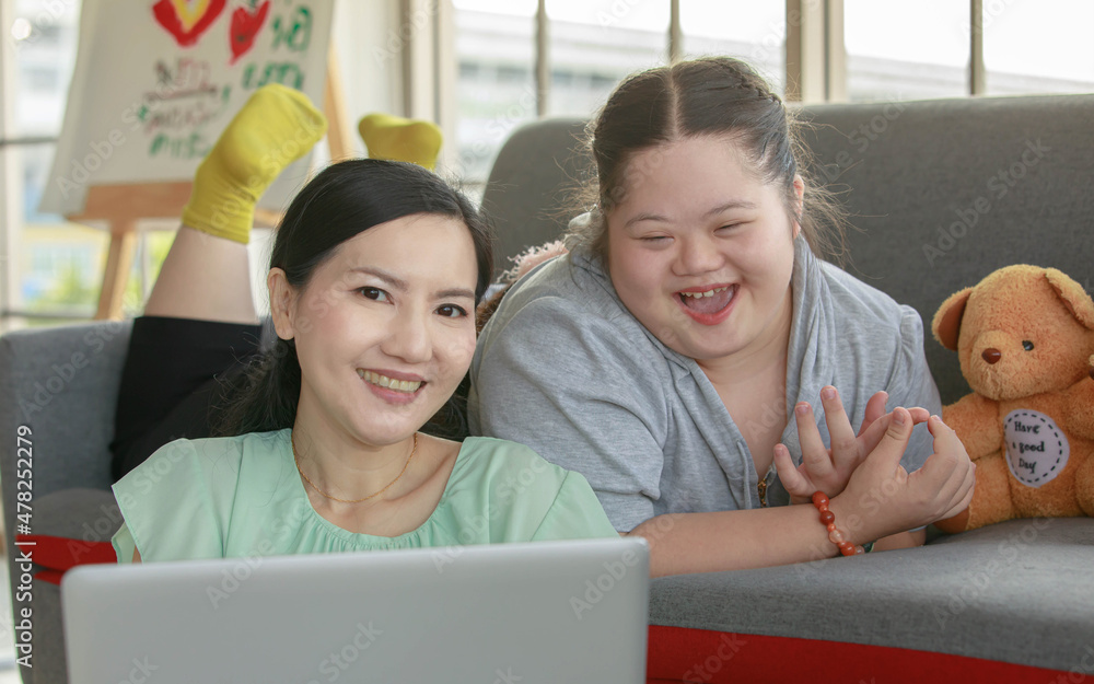 Portrait shot of Asian lovely mother sitting on floor and young chubby ...
