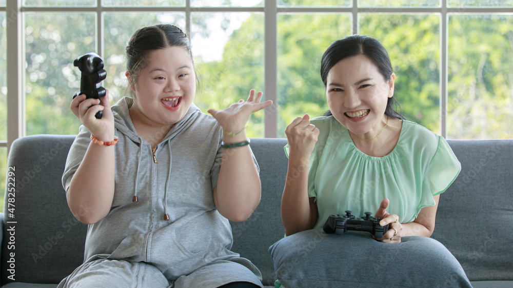 Asian happy funny lovely mother and young chubby down syndrome autistic ...