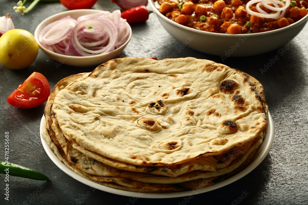 Indian roti- whole wheat flat bread served with onion salad and ...