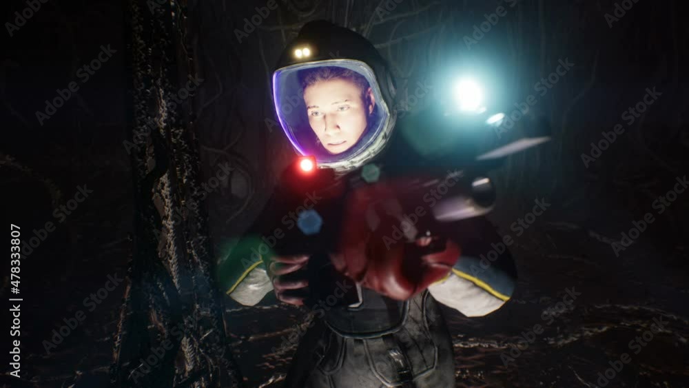 An astronaut with a blaster sneaks through an eerie alien dungeon on an ...