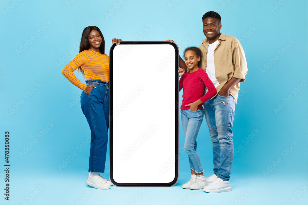 Black family showing white empty smartphone leaning on big screen Stock ...