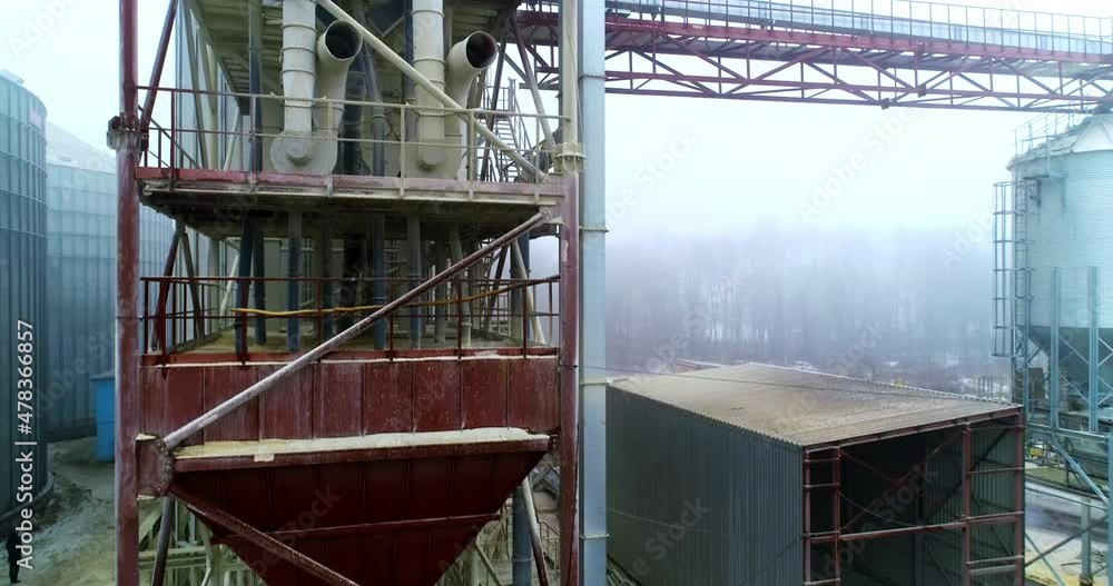 Metal supports, ladders and pipes at the tanks of modern silo plant ...
