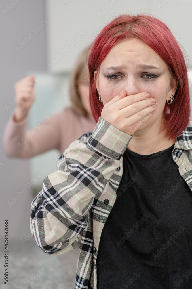 Family conflict. Mother screams at crying teen daughter at home Stock ...