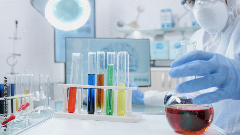 Scientist researcher doctor using medical transparent glasses mixing ...