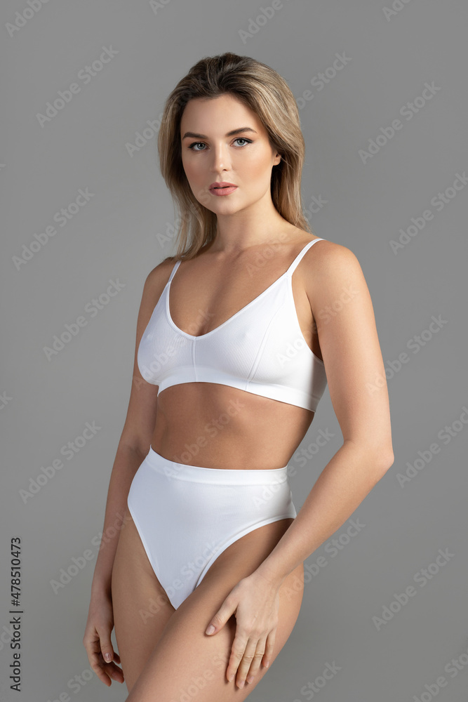 Beautiful Young Woman Wearing White Lingerie Isolated On Gray