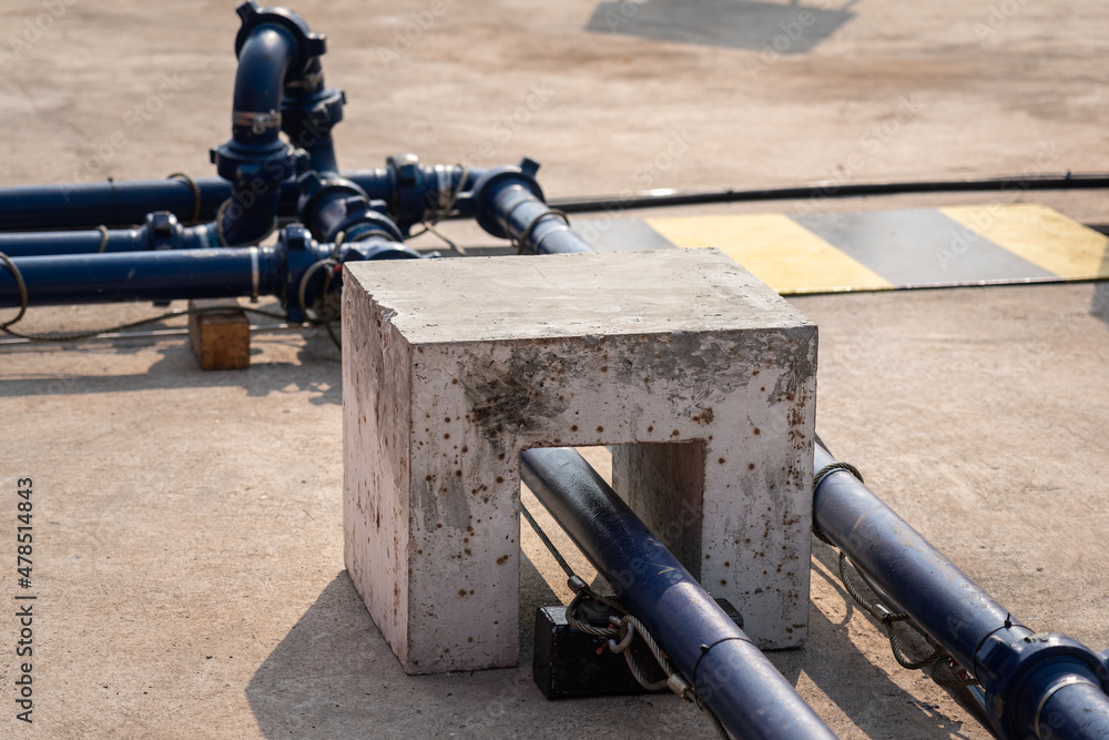 A heavy concrete block which is use to secure the high pressure ...