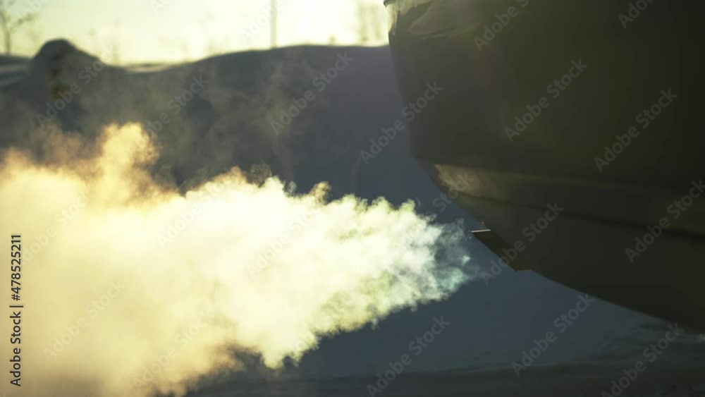 combustion fumes coming out of car exhaust pipe, exhaust gases close up ...