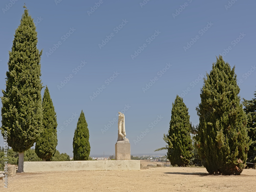 Remains of stone statue of emperor Trajan in between trees on trajano ...