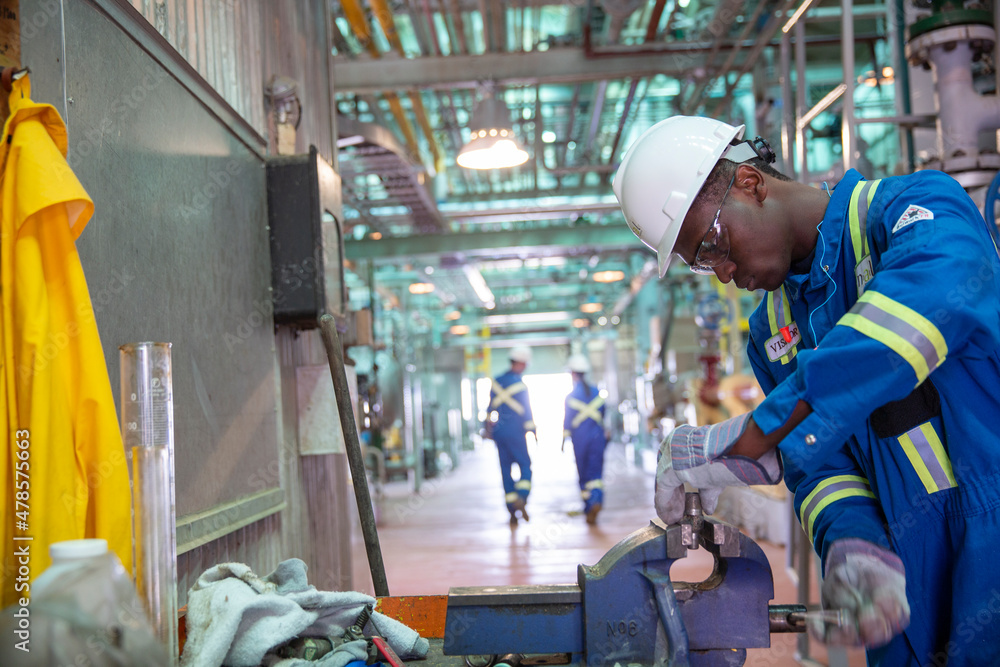 Male worker using vise grip in gas plant Stock Photo | Adobe Stock