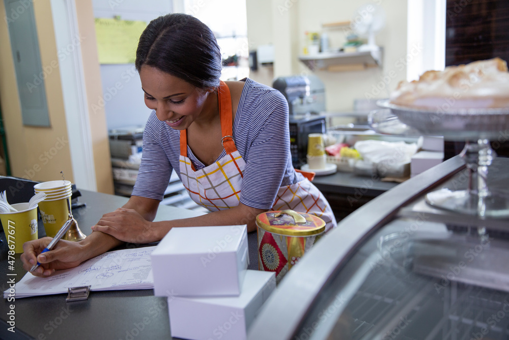 Portrait of female small business owner in store entrance Stock Photo ...