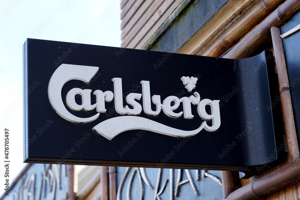 Carlsberg text brand and sign logo of beer front of bar restaurant in ...