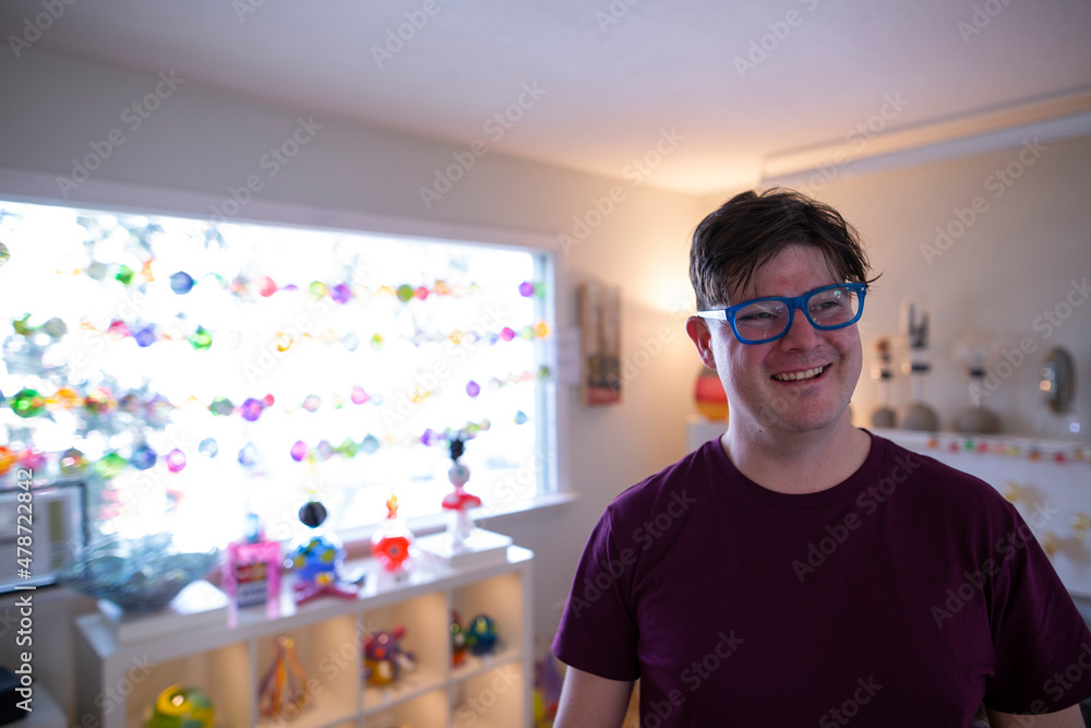 Glassblower arranging display in retail shop window Stock Photo | Adobe ...