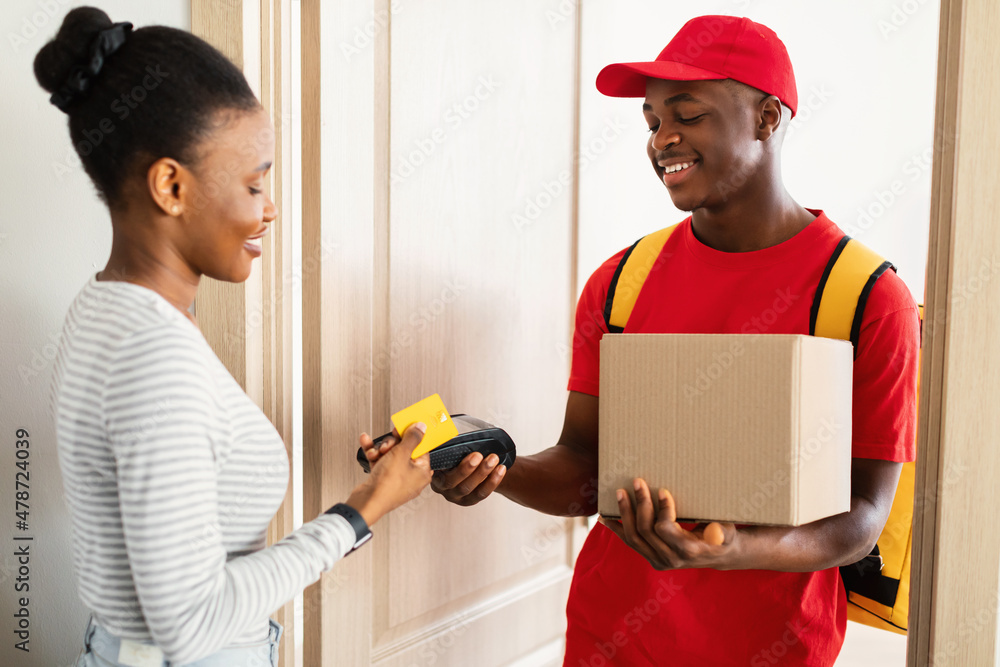 Courier Receiving Payment With Credit Card From Female Customer Indoor ...