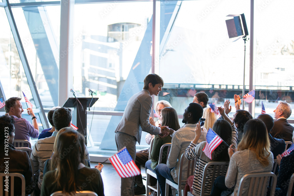 Smiling female politician speaking at political rally Stock Photo ...