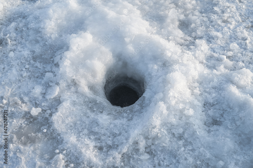 Holes in the ice - winter fishing. Stock Photo | Adobe Stock