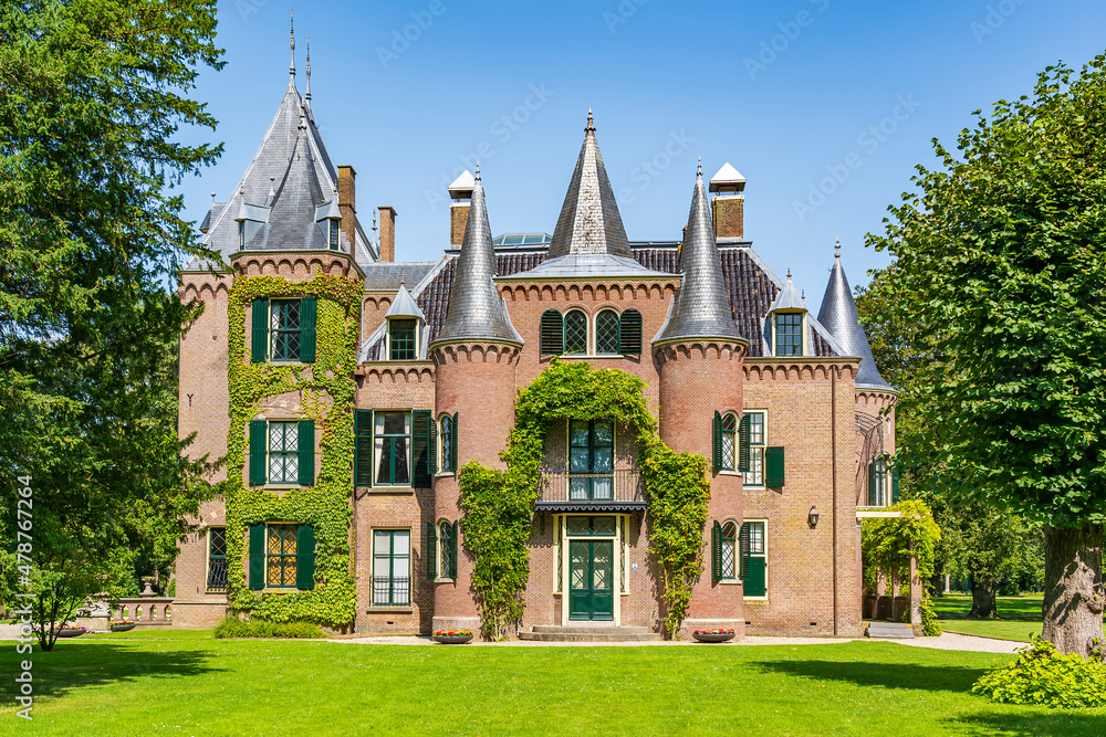 The side view of a castle, partly overgrown with beautiful ivy, in a ...