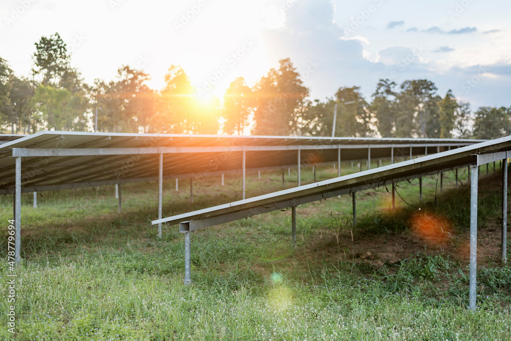 sun above solar farm renderings Clean energy. Stock Photo | Adobe Stock