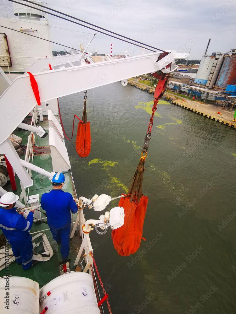 bags for overload test of lifeboat crane on board a ship in a dry dock ...