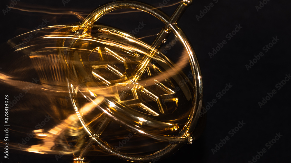 Golden Gyroscope Spinning Wildly on its Base Stock Photo | Adobe Stock