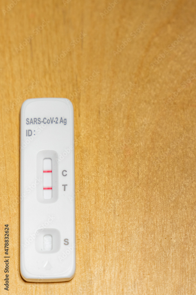 Positive covid-19 auto test with two red lines appearing on the test ...