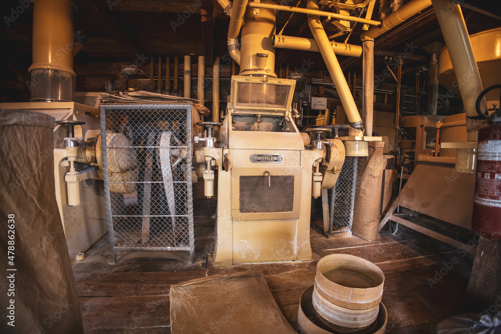 Old machine for powering spinning stone to crush grains for flour ...