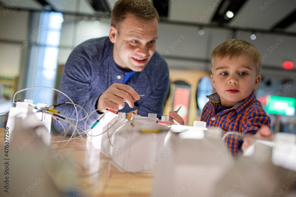 Father and son playing electricity grid science center Stock Photo ...