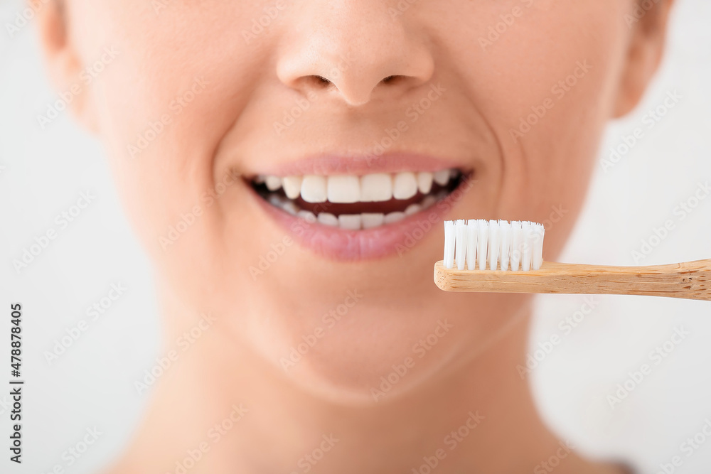 Woman with bamboo tooth brush on light background, closeup Stock Photo ...