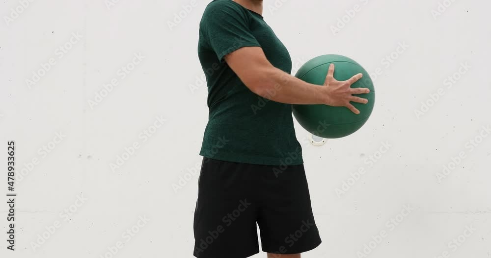 Fitness training. Medicine ball exercises - standing rotation side to ...