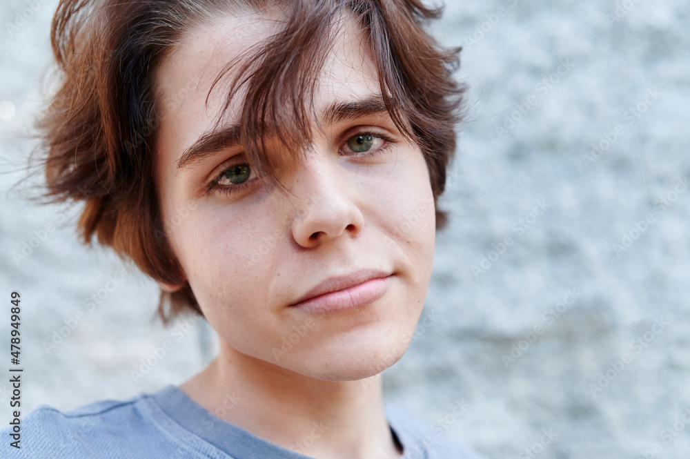 Smiling young trans person standing outside Stock Photo | Adobe Stock